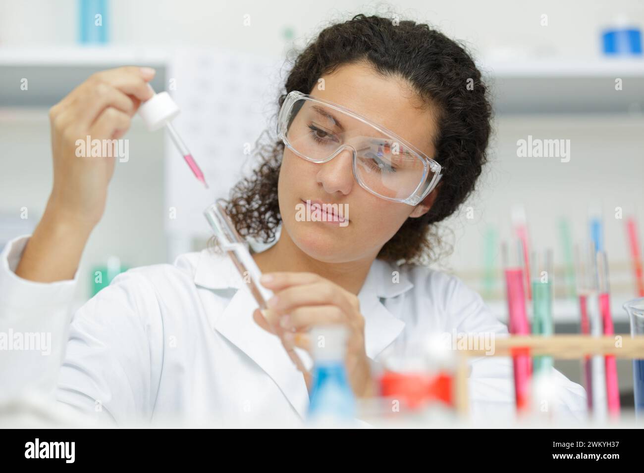 woman doctor with reaction tube and pipette during examination Stock ...