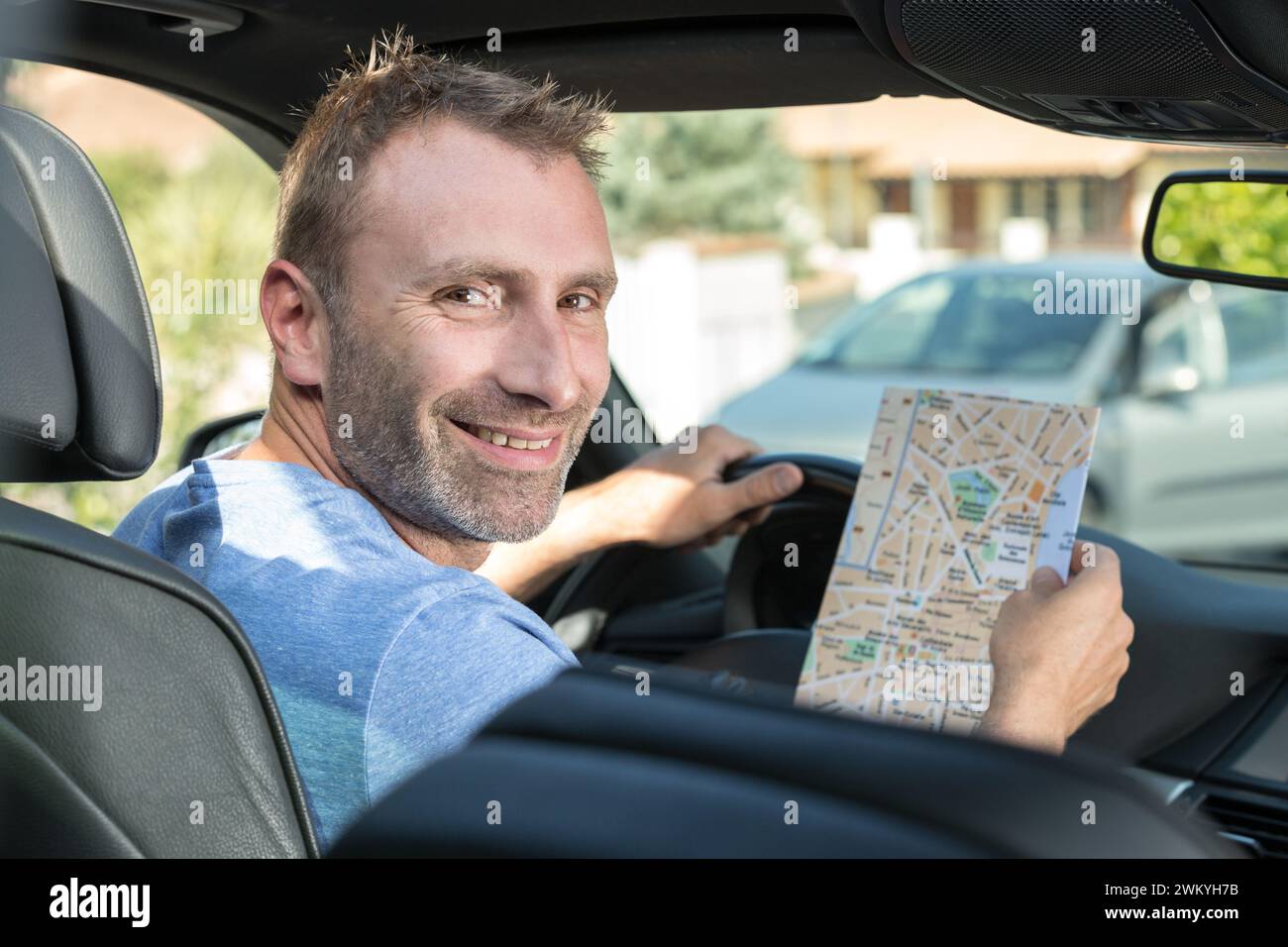 man in car with a map Stock Photo - Alamy