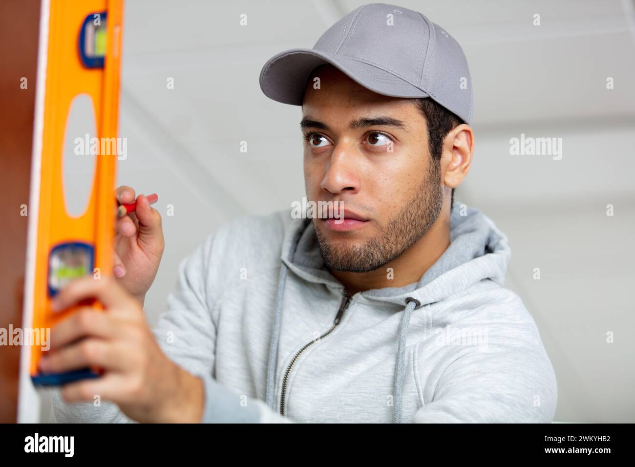 engineer checking wall with spirit level Stock Photo - Alamy