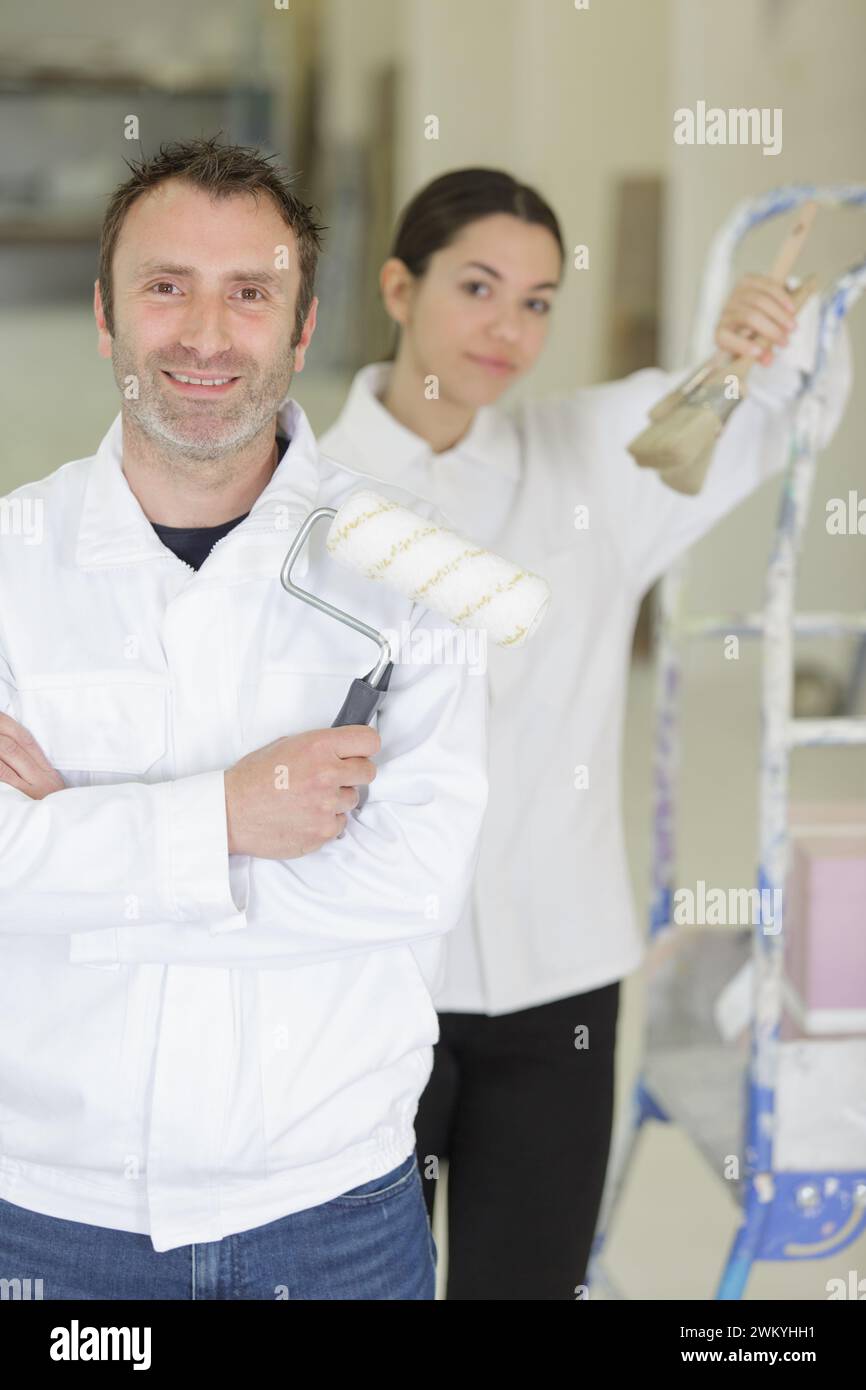 male and female painting and decorating team Stock Photo - Alamy