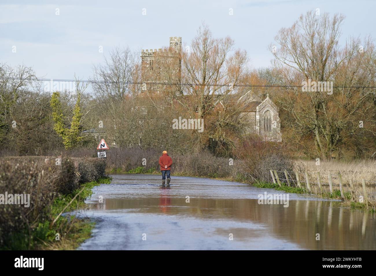 Aman looks at floodwater in Harbridge, Hampshire. Schools have been ...