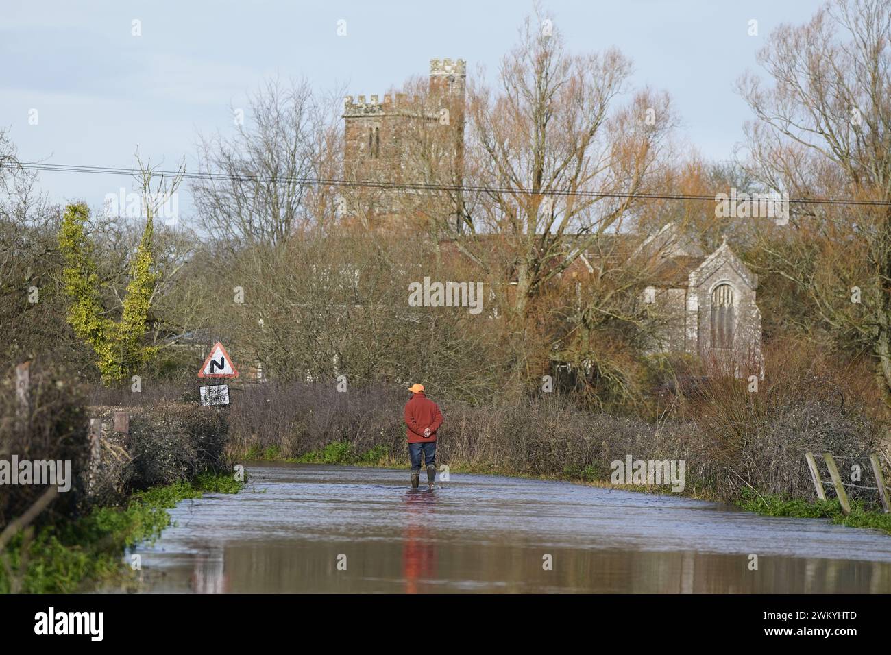 Aman looks at floodwater in Harbridge, Hampshire. Schools have been ...