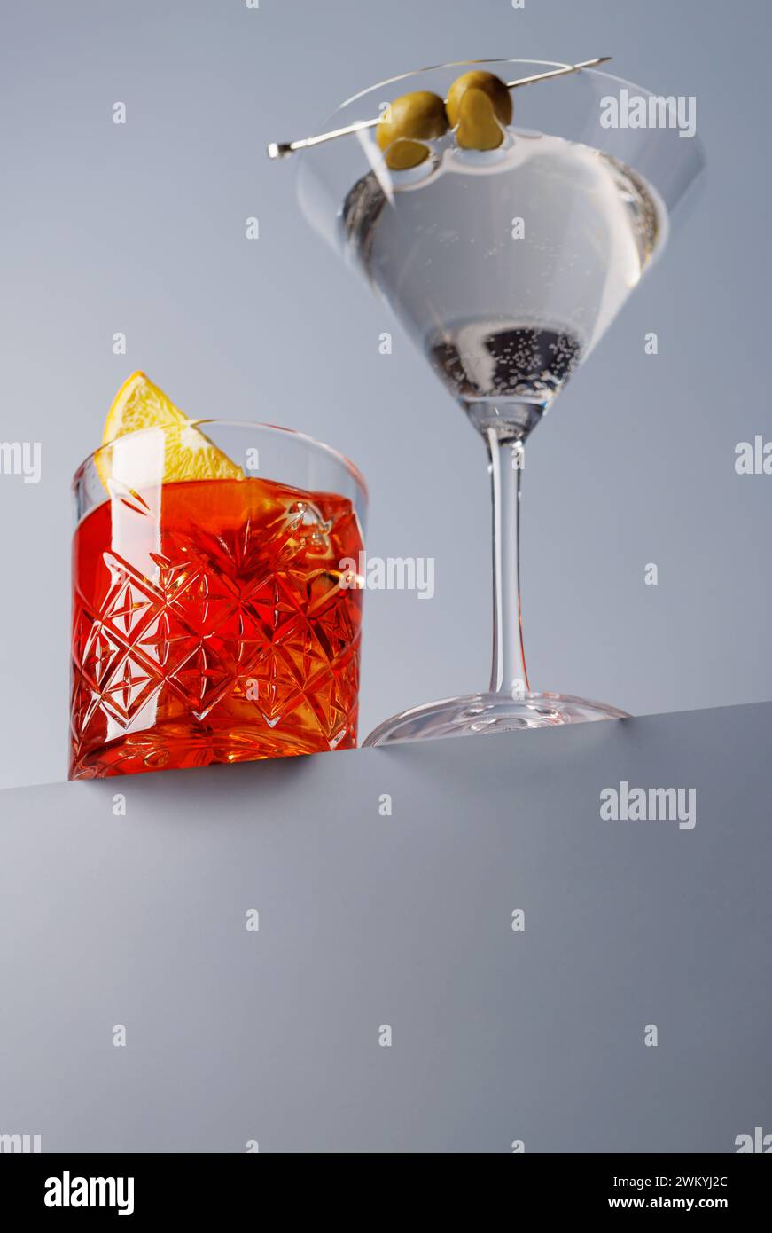 Cocktail delight: Vibrant drinks against a grey background with copy ...