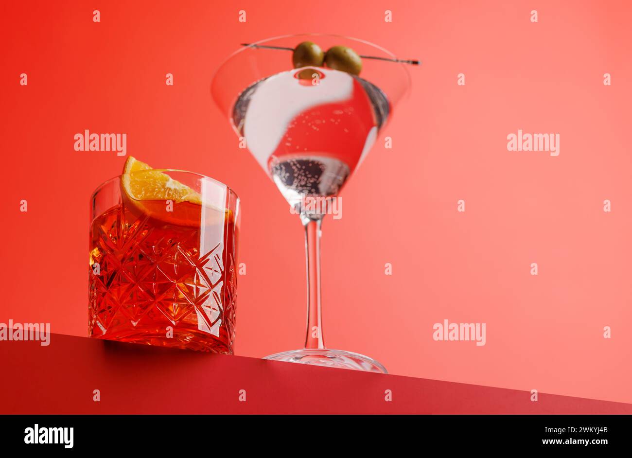 Cocktail delight: Vibrant drinks against a red background with copy ...