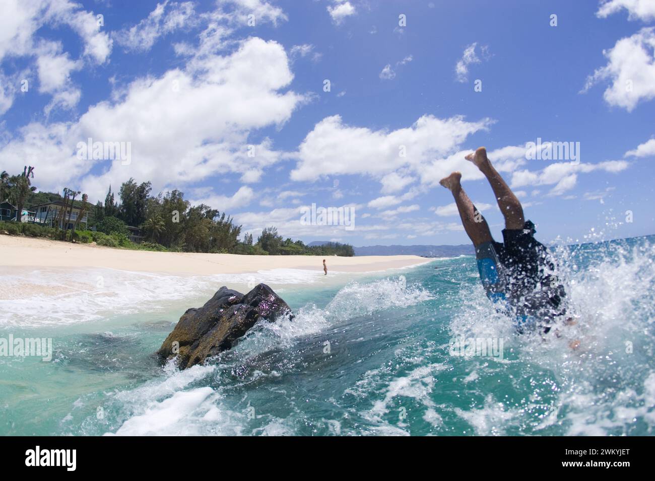 man diving from rock into ocean wave Stock Photo - Alamy