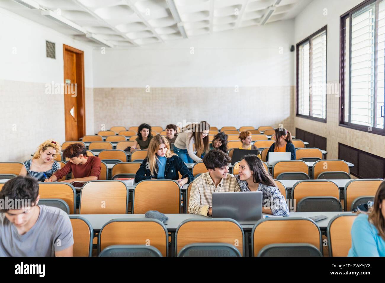 Young people studying inside university classroom - Education concept ...