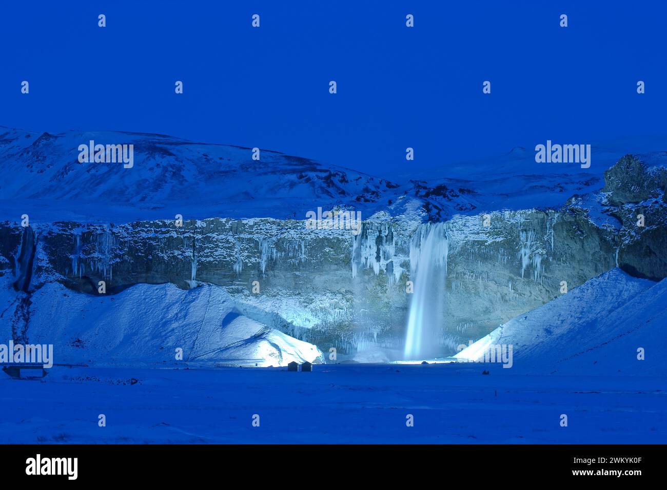 Waterfall in winter landscape at dusk Stock Photo - Alamy
