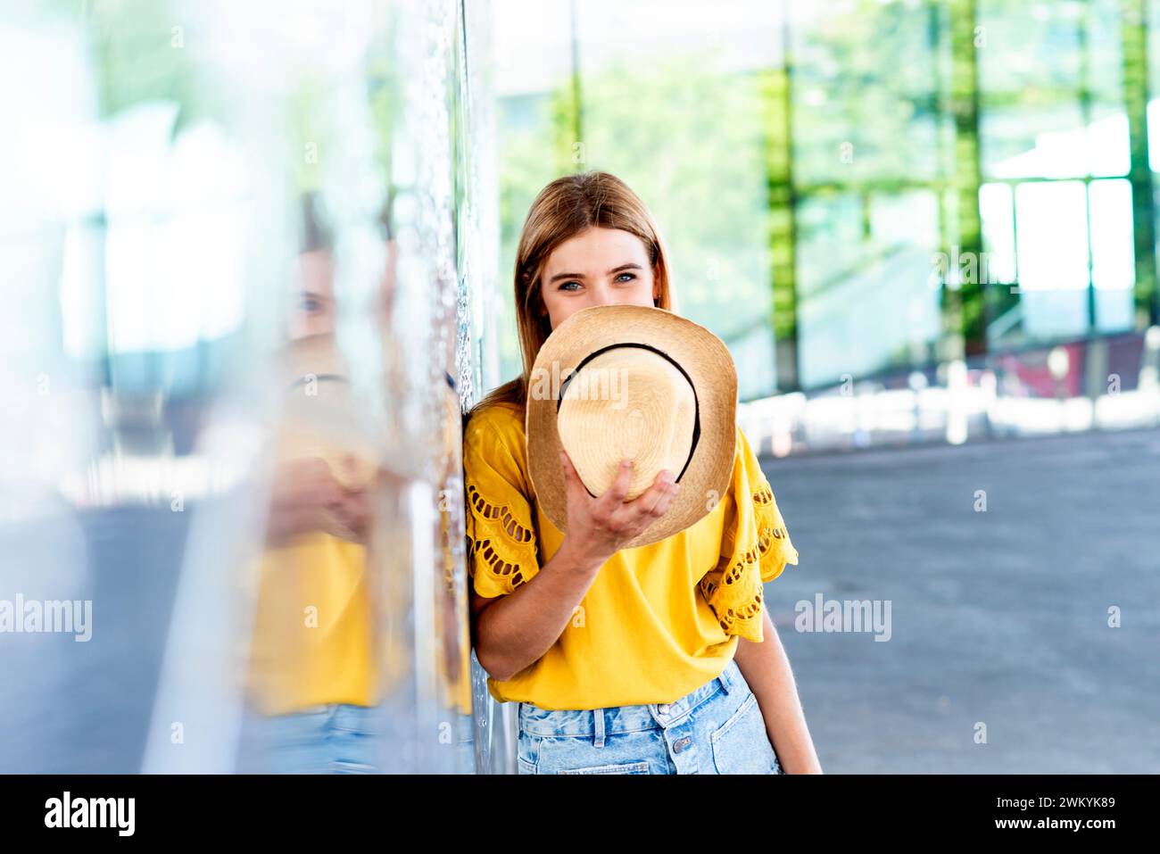 This photo captures a playful peek-a-boo moment with a young woman ...