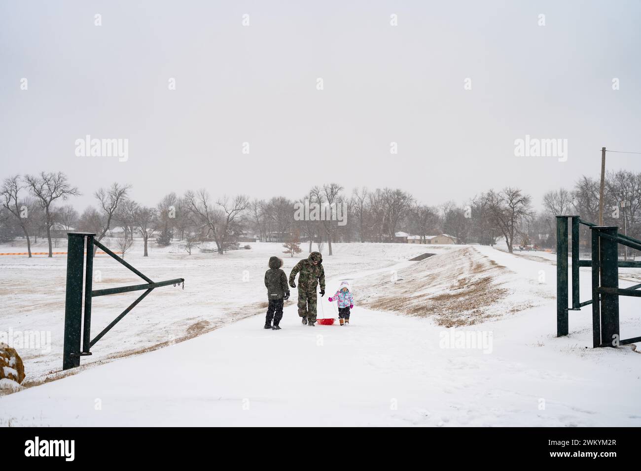 Father sledding daughter in snow hi-res stock photography and images ...