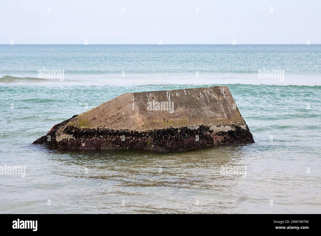 Part of German WWII bunker protruding from the sea at Noerlev Beach on ...