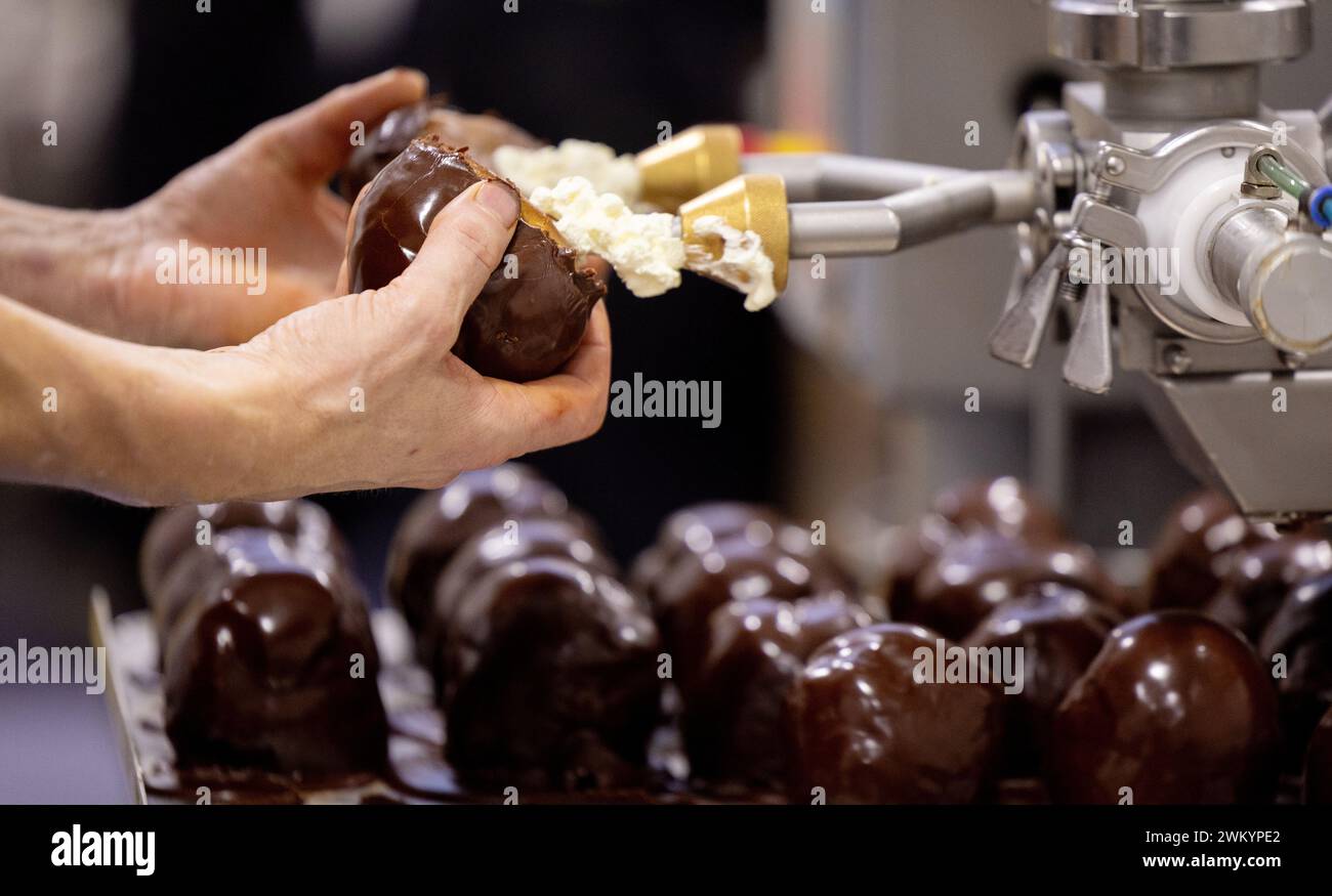DEN BOSCH - Bossche Bollen are filled in the bakery of Banketbakkerij ...