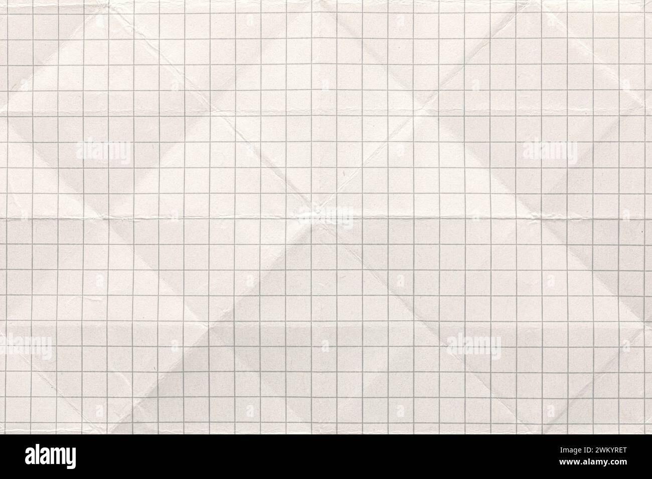 A wrinkled sheet of white grid paper displayed unfolded Stock Photo - Alamy