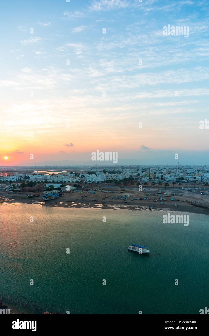 Sunset in Sur town. View on west part of the Sur city. Dhow Factor in ...