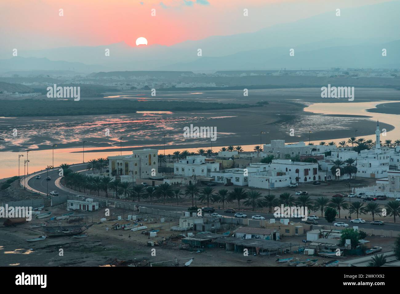 Sunset in Sur town. View on west part of the Sur city. Dhow Factor in ...