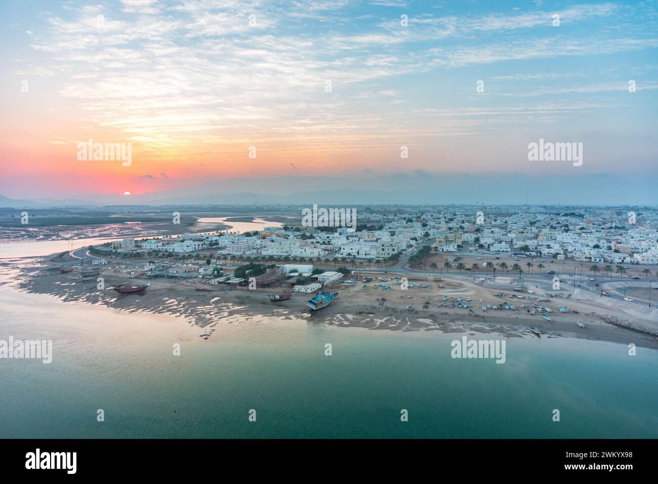 Sunset in Sur town. View on west part of the Sur city. Dhow Factor in ...