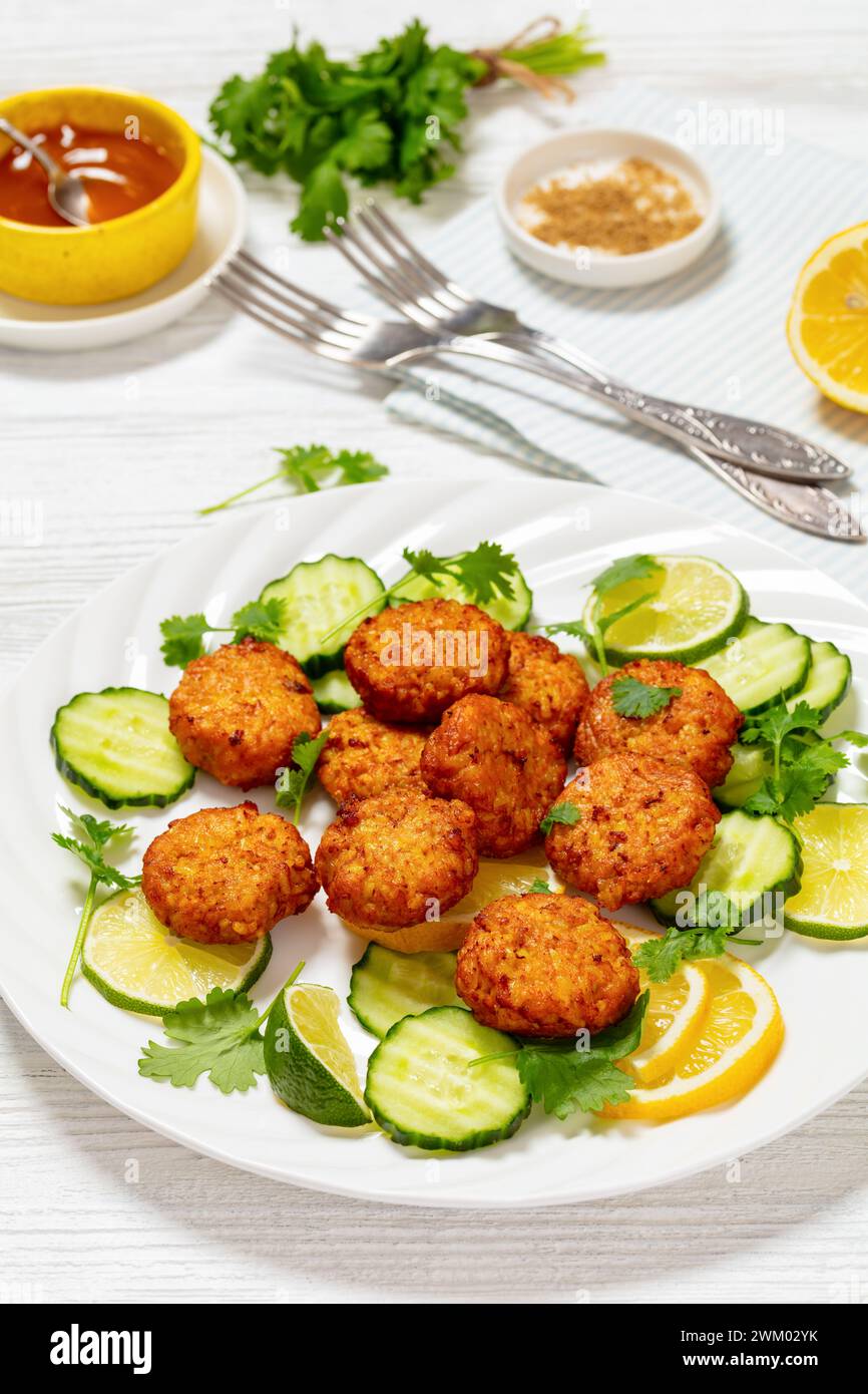 fried rice patties, rice tikki, indian style on white plate served with ...