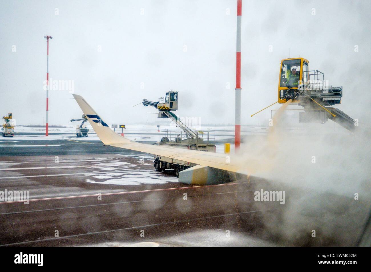 A Finnair plane being de-iced at Helsinki airport Stock Photo - Alamy