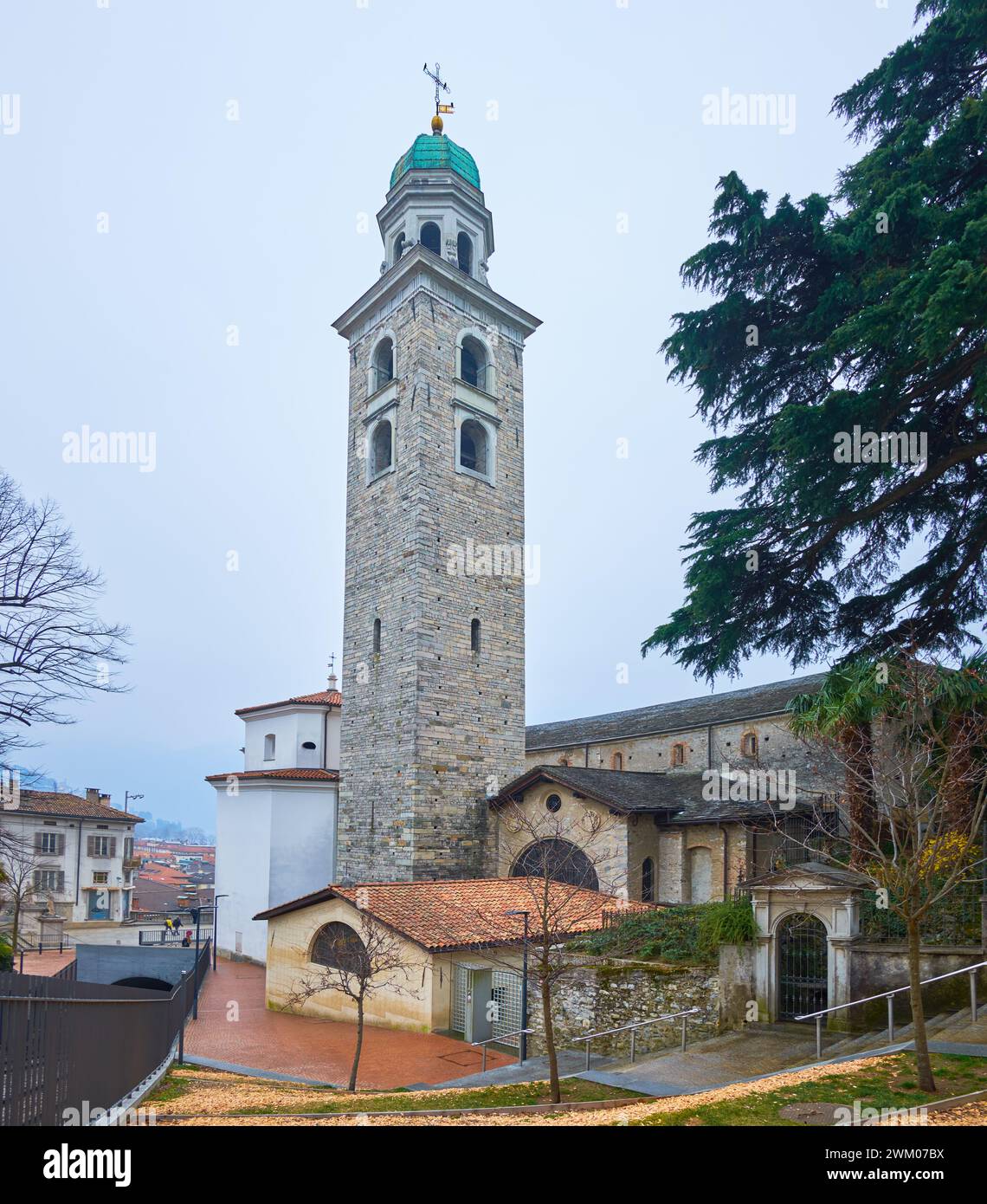 Lugano Cathedral (Cattedrale di San Lorenzo) with high stone bell tower ...