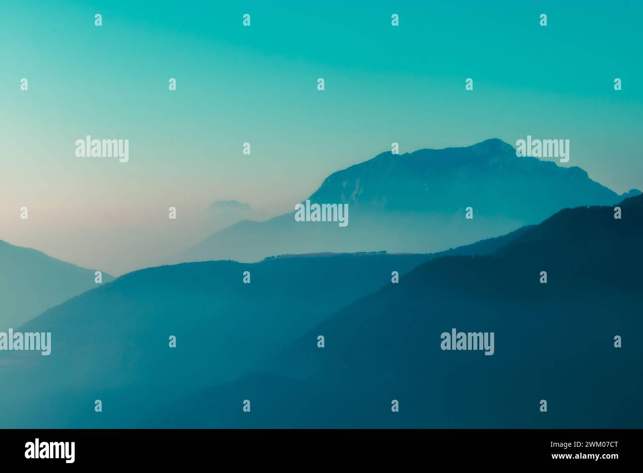 Spectacular mountain ranges silhouettes in shades of green Stock Photo ...