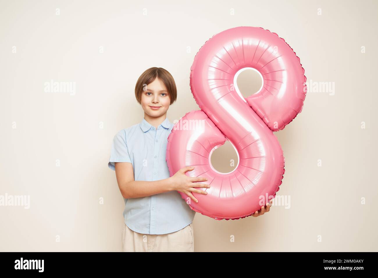 Cheerful happy child with balloon number 8. Smiling boy on white ...