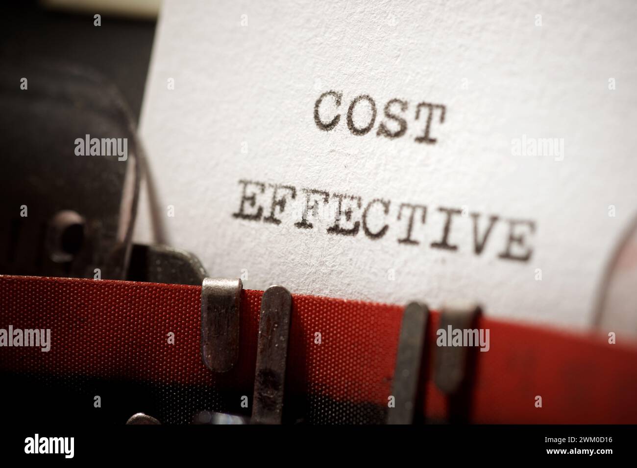Cost effective text written with a typewriter Stock Photo - Alamy