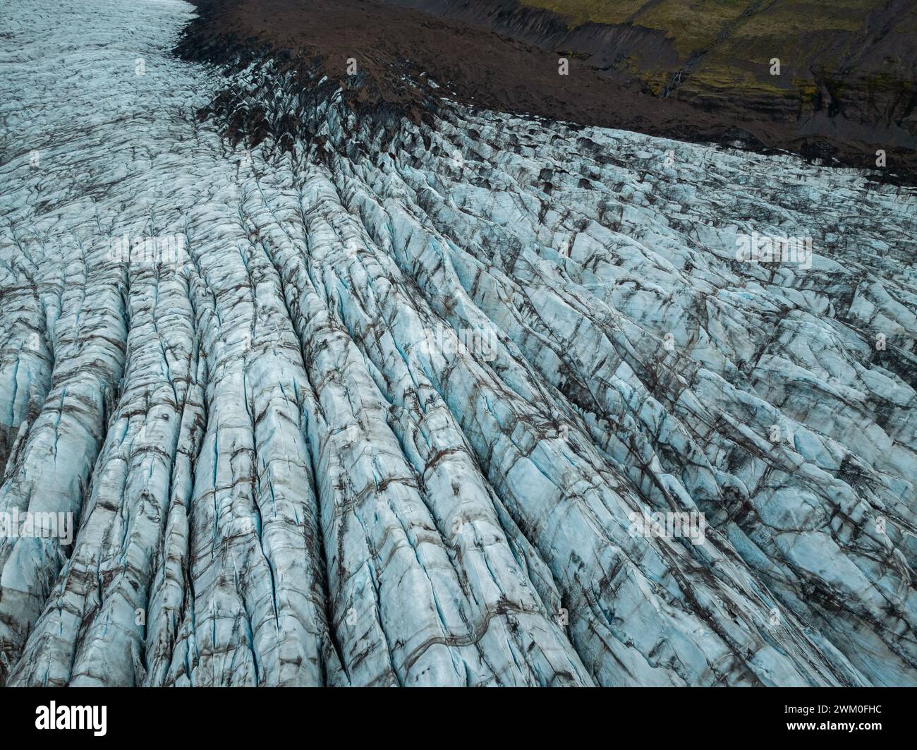 Dark gray volcanic rock formation formed from cooled lava, aerial top ...