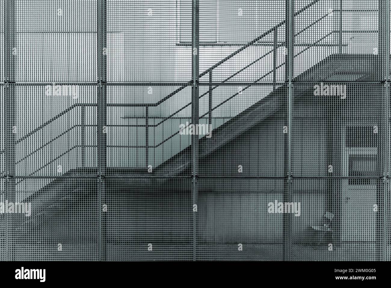 Metal cage and door in front of office building concealing stairs and ...