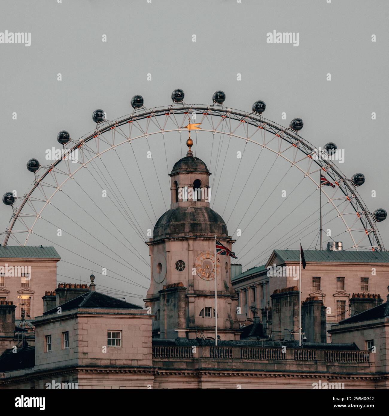 The London Eye overlooking city hall, tall buildings, and clock tower ...