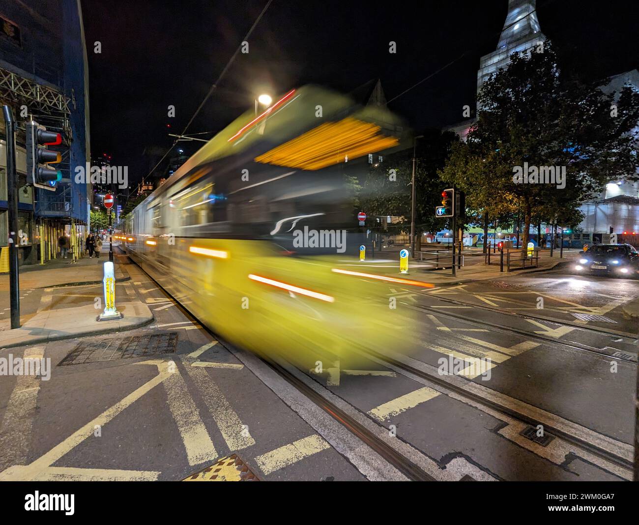 A tram is photographed moving through the centre of Manchester Stock ...