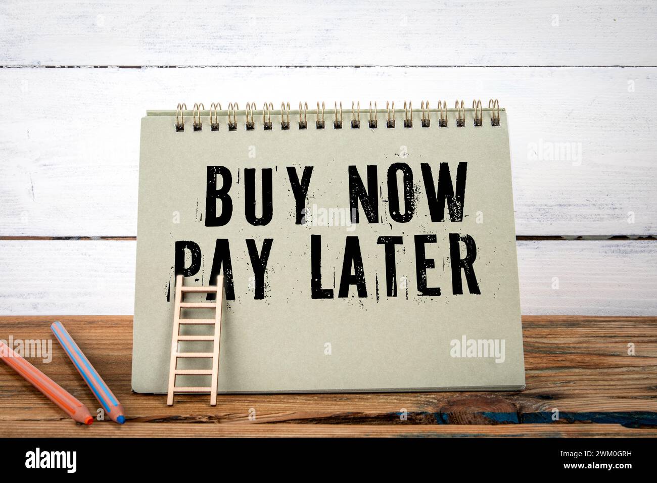 Buy Now Pay Later. Green notepad on wooden texture table and white ...