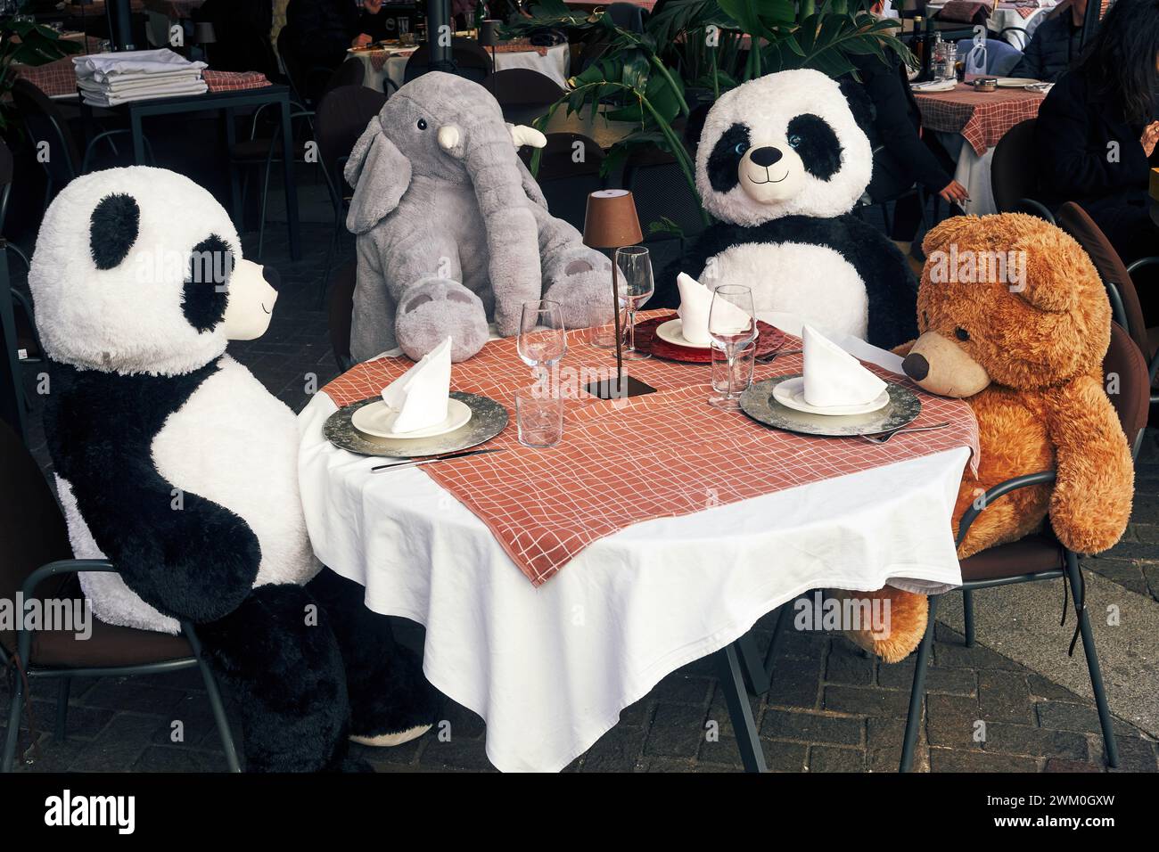 Stuffed animals sitting at a table, having a lunch party Stock Photo ...