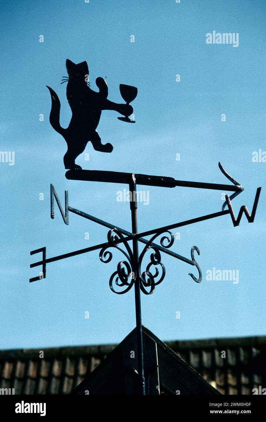 Weather vane UK on the farmhouse shows a cat and a glass of wine ...