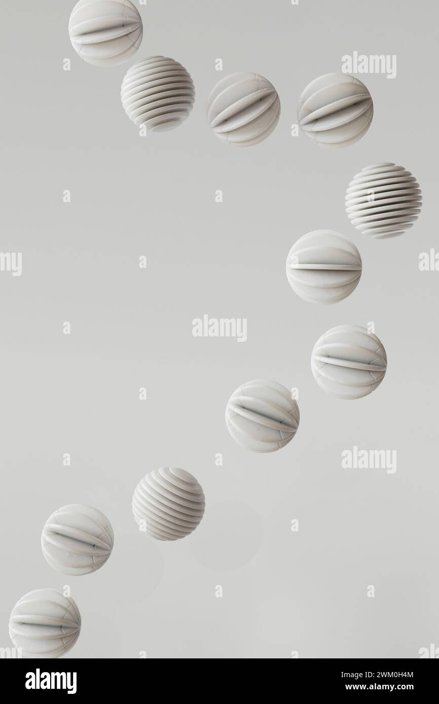 3D render of striped spheres floating against white background Stock ...