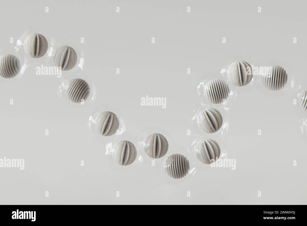 3D render of plastic wrapped spheres floating against white background ...