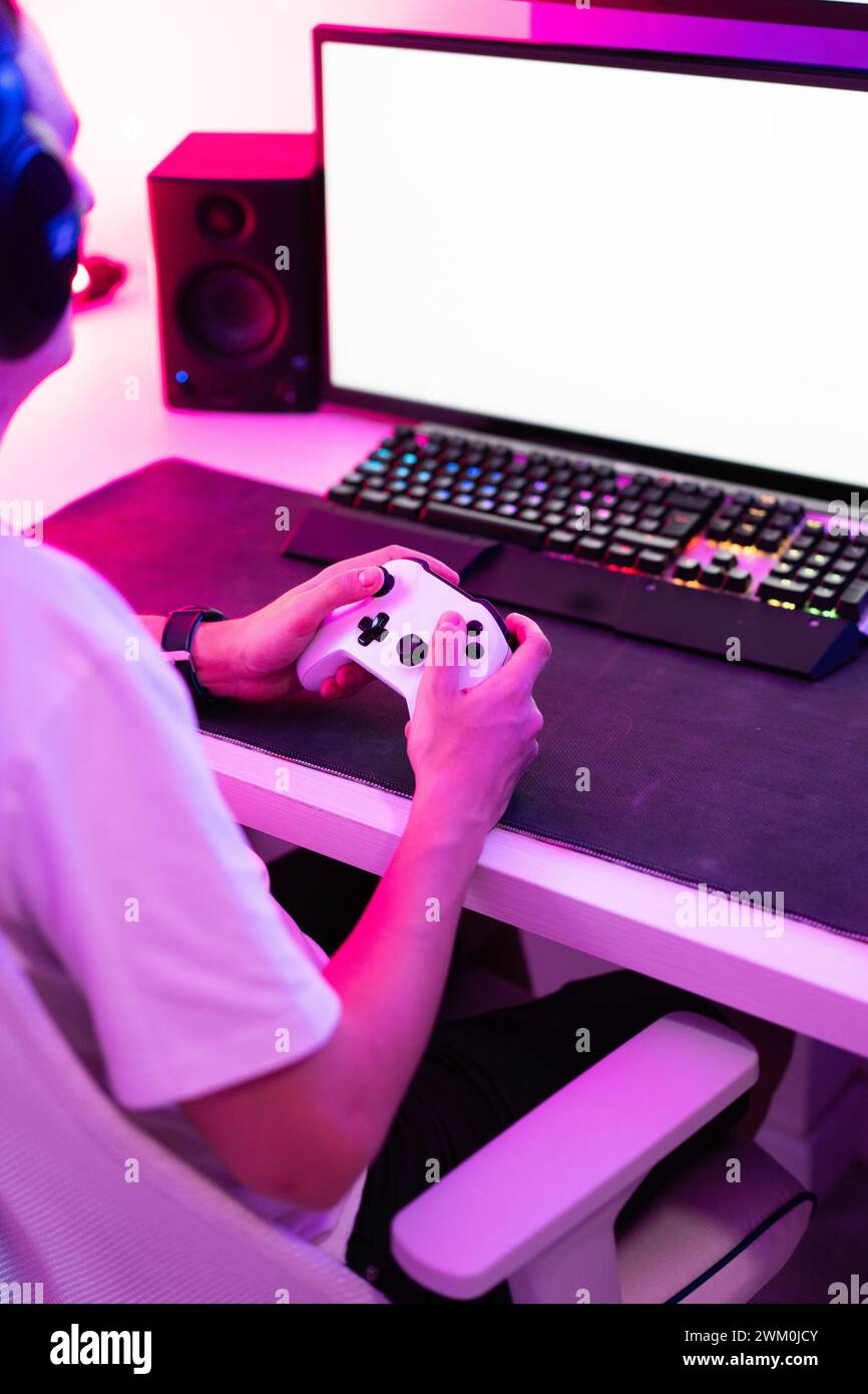 Gamer playing video game on desktop Stock Photo - Alamy