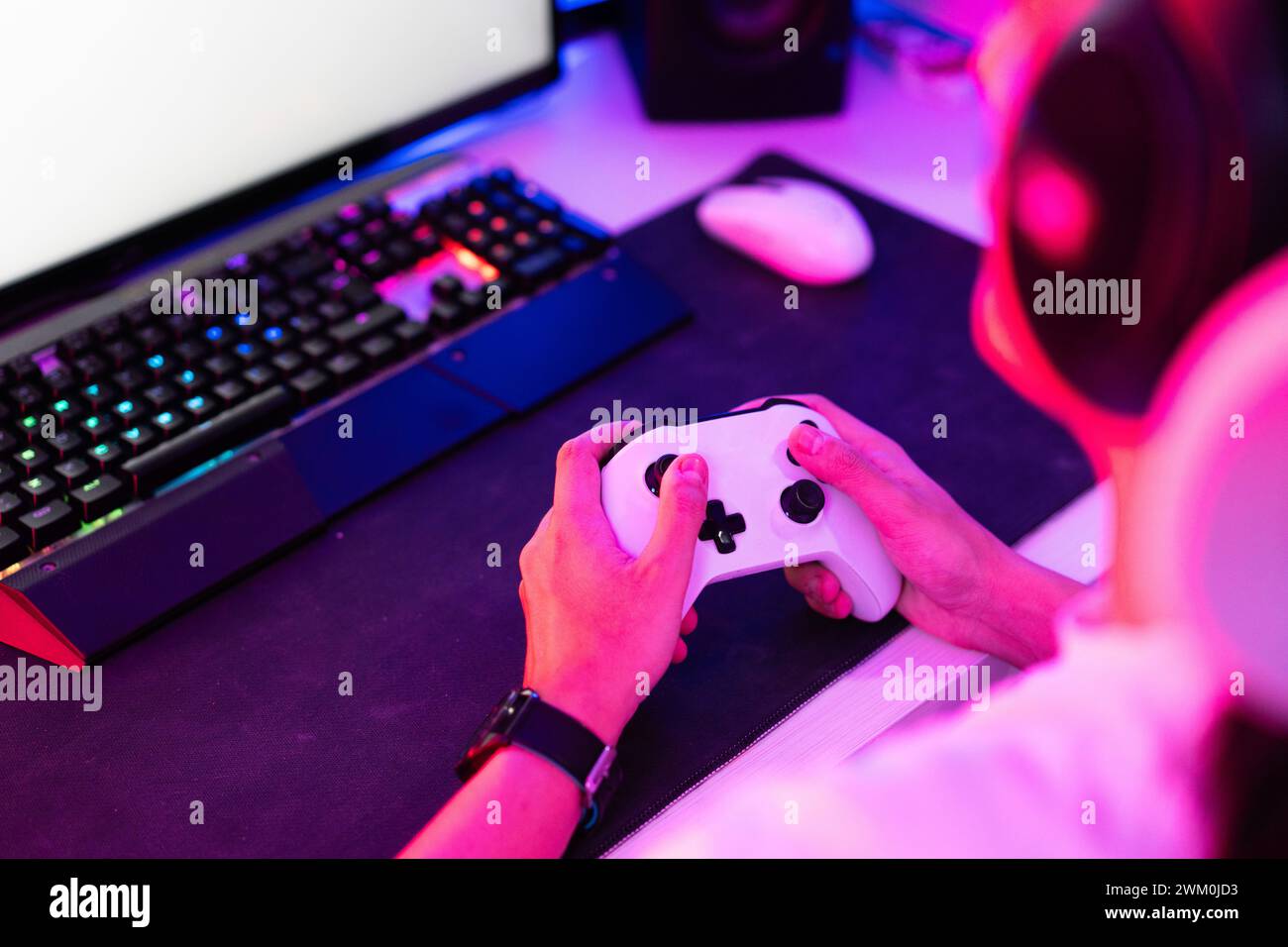 Gamer holding gamepad and playing video game on desktop Stock Photo - Alamy
