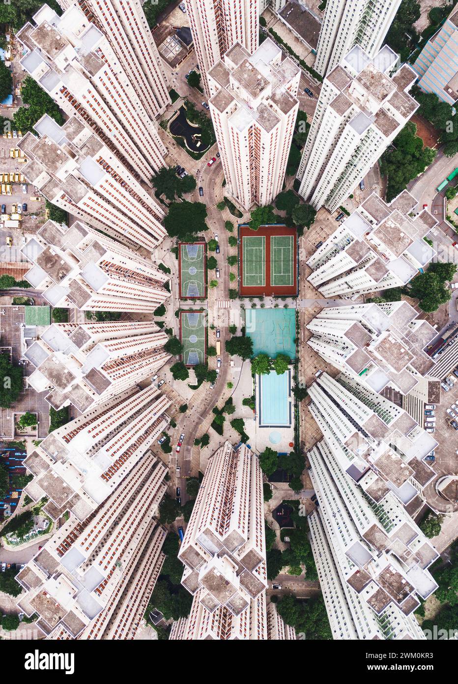 Swimming pool with sports courts near tall buildings in Hong Kong city ...