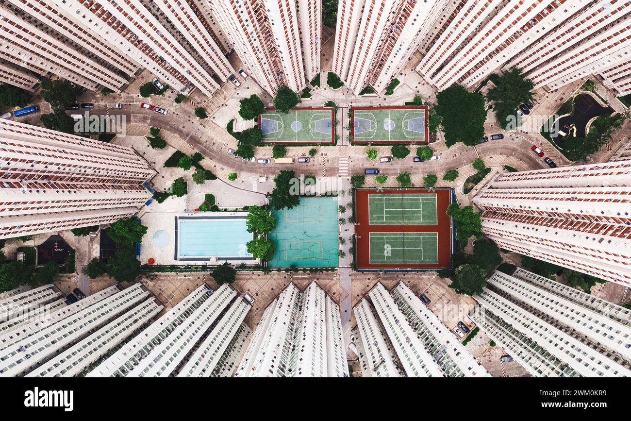 Sports courts with swimming pool near tall buildings in Hong Kong city ...