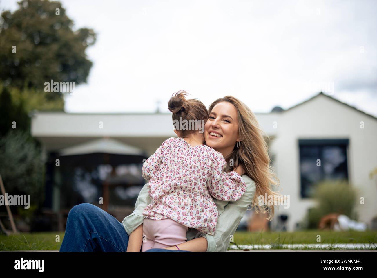 Rear view of parents hugging child hi-res stock photography and images ...