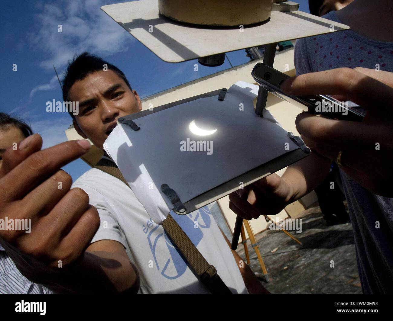 FILE - Vietnamese student Dang Anh Tuan shows a projected image of a solar eclipse at an ...
