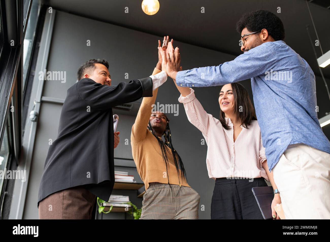 Cheerful business group giving high hi-res stock photography and images ...
