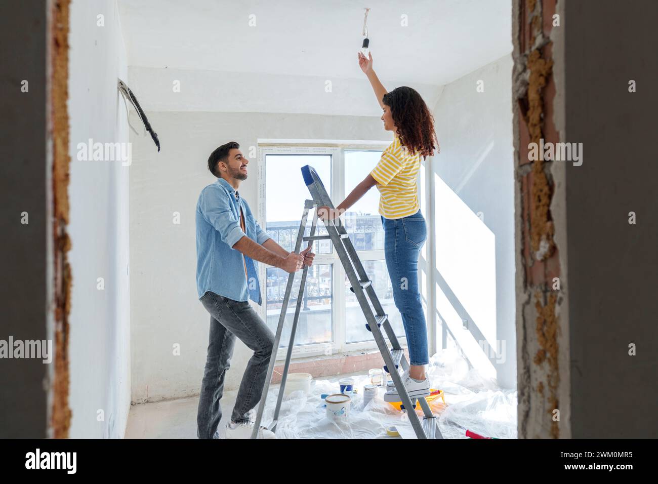 Woman changing light bulb hi-res stock photography and images - Alamy