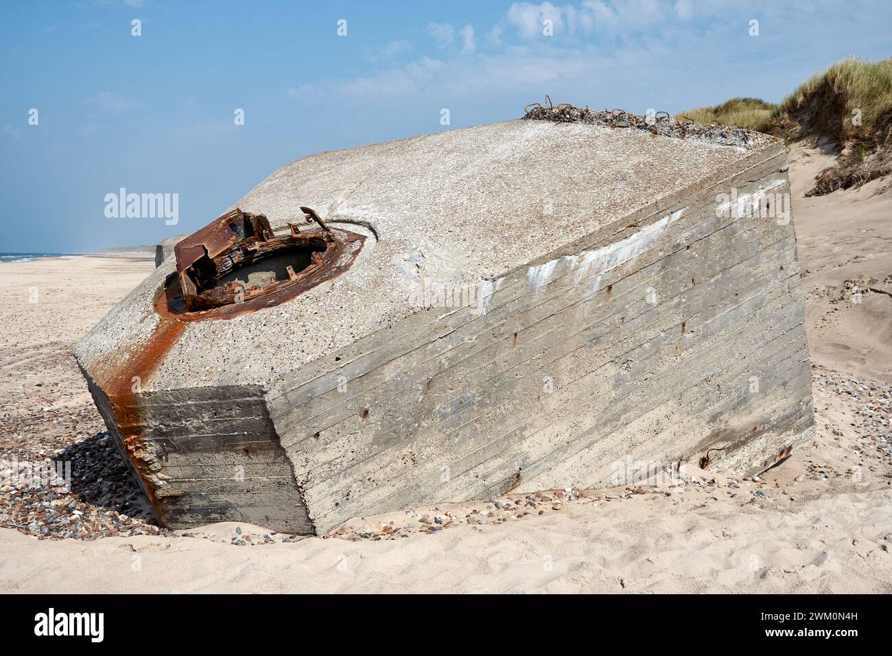 German WWII bunker partly buried in sand at Noerlev Beach on the west ...