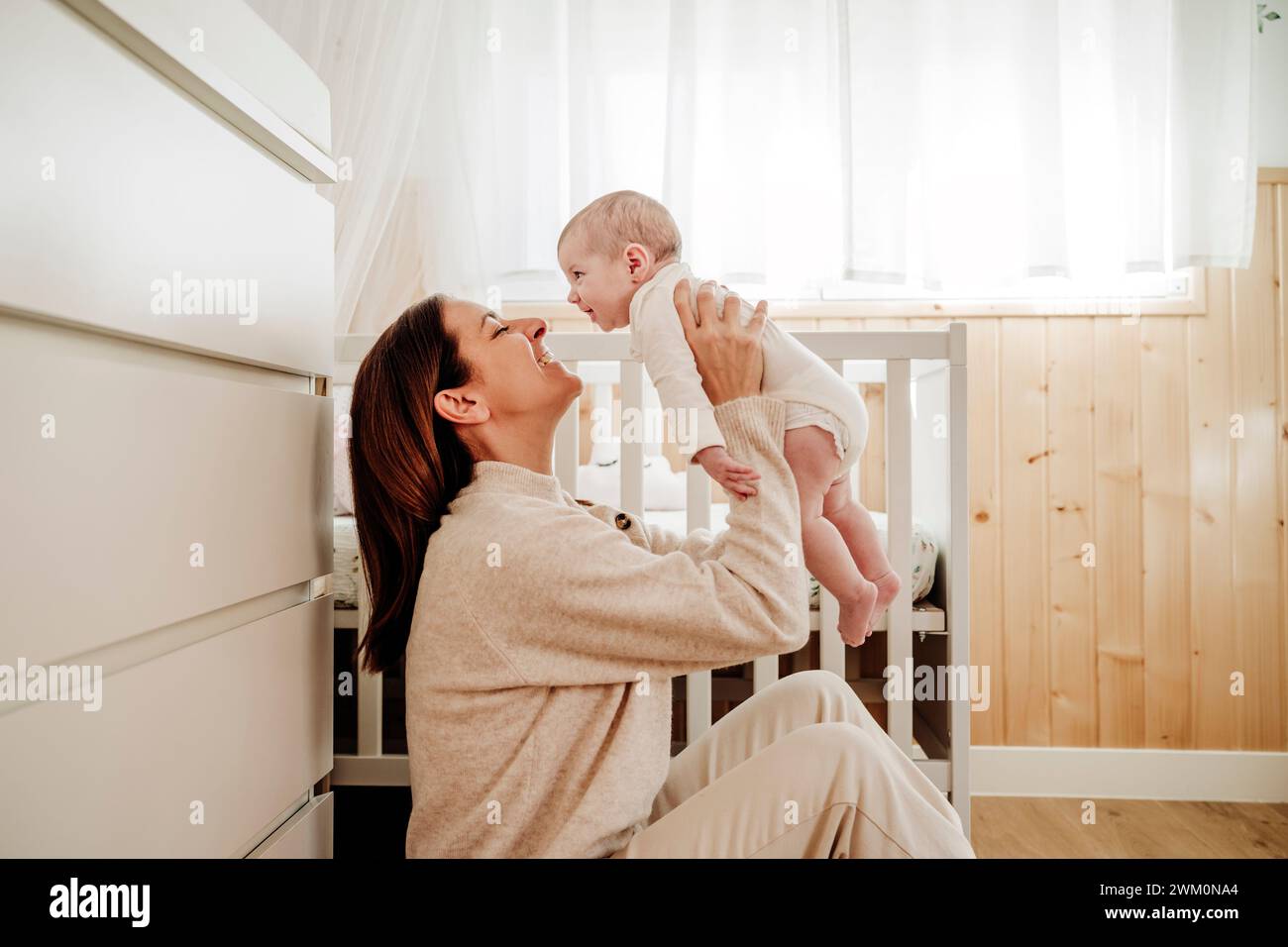 Mother embracing baby girl hi-res stock photography and images - Alamy