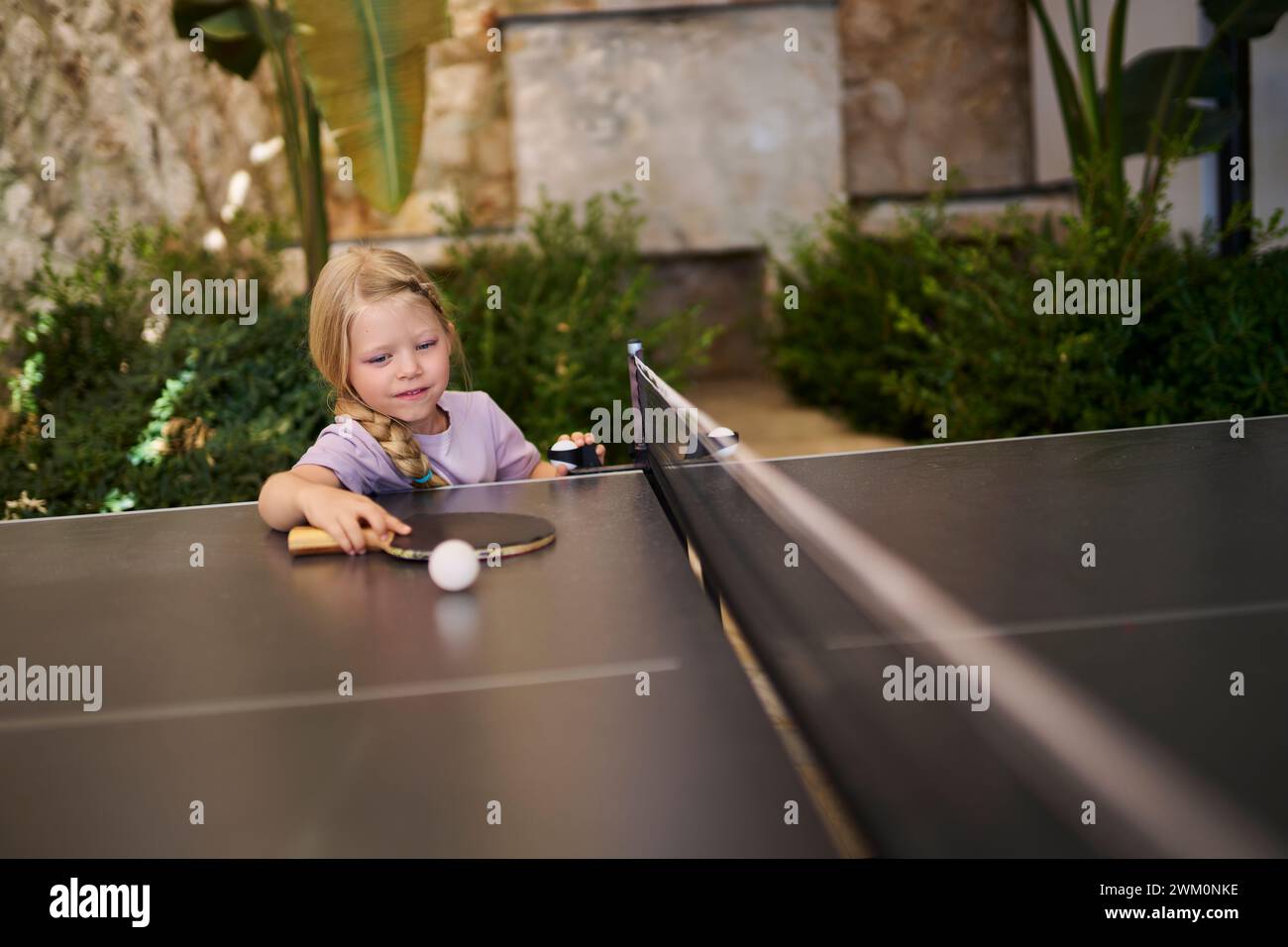 Girl playing table tennis at villa Stock Photo - Alamy