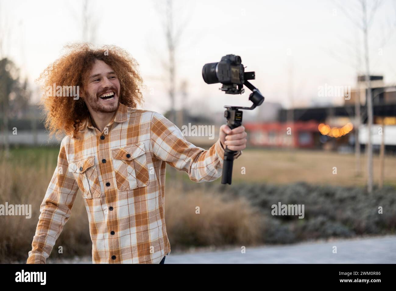 Happy influencer vlogging through camera Stock Photo - Alamy