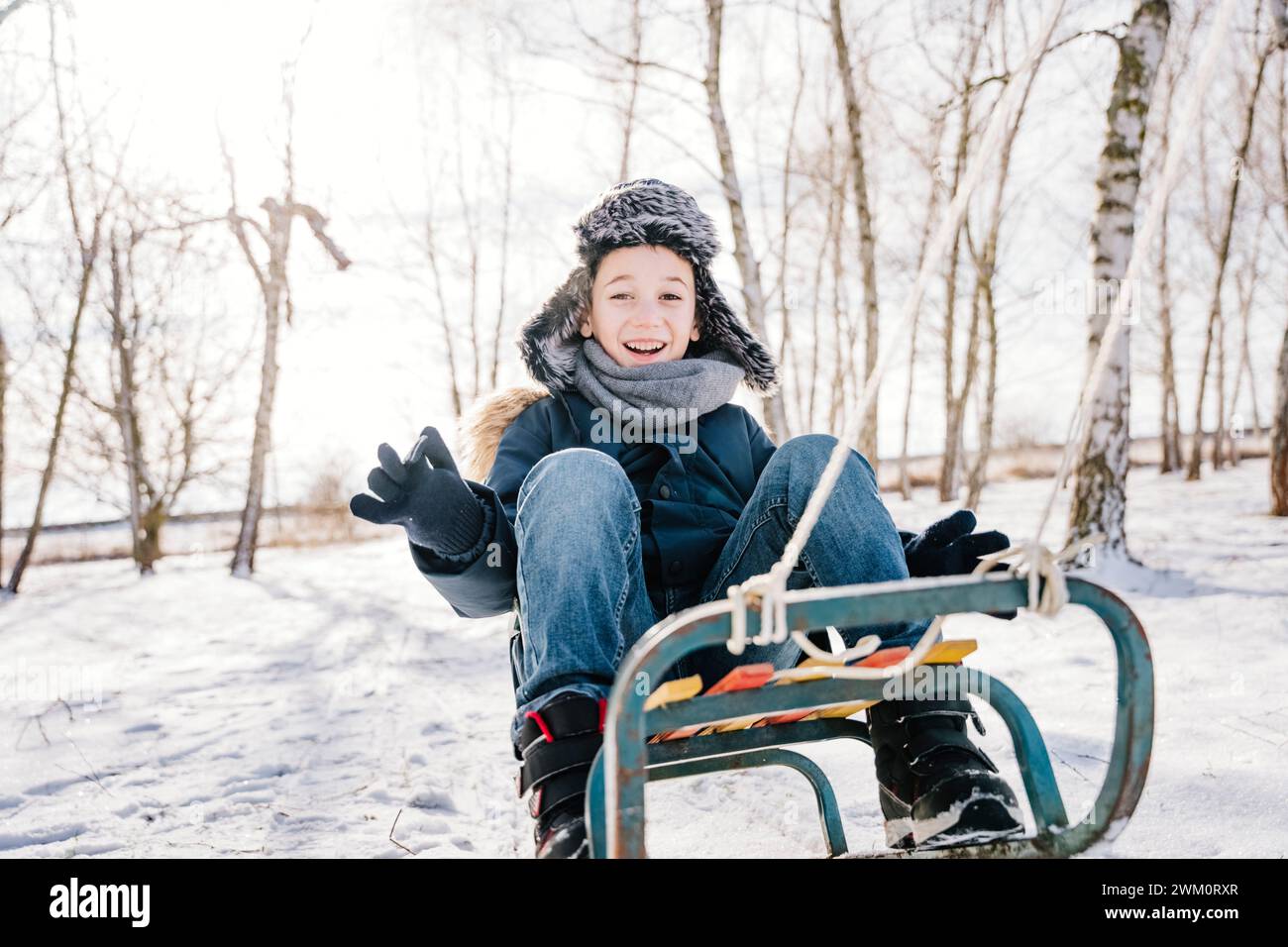 Happy boy sitting winter hi-res stock photography and images - Alamy