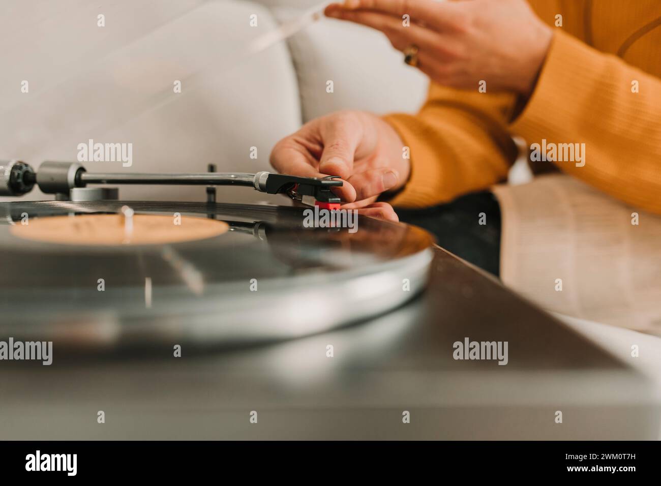Man adjusting needle over record on turntable Stock Photo - Alamy