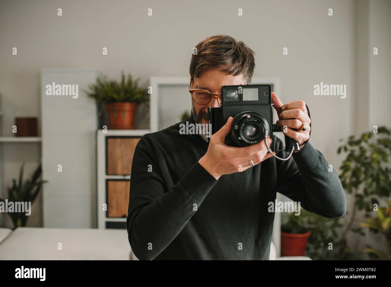 Man photographing instant camera hi-res stock photography and images ...