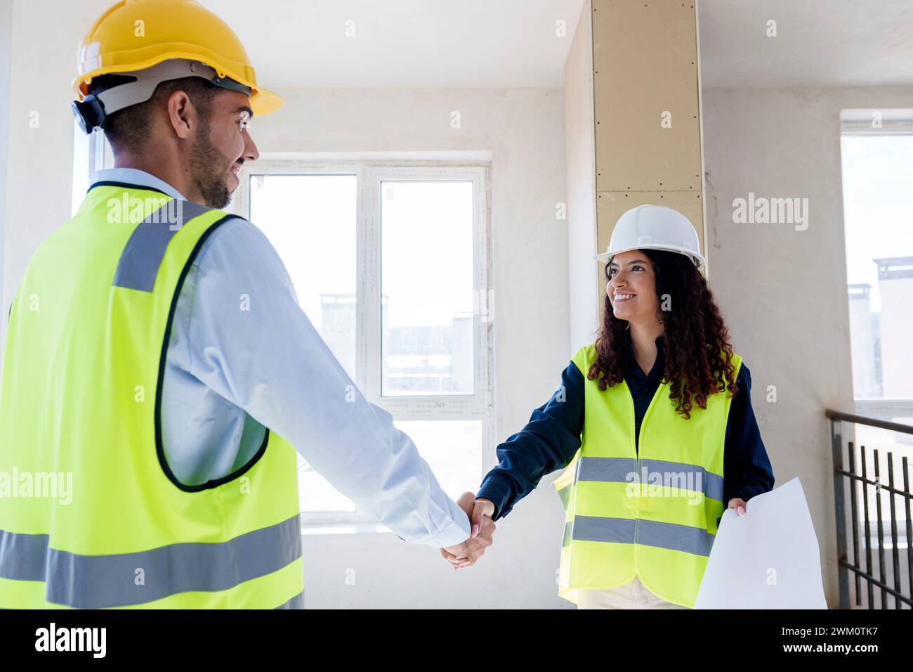 Woman man shaking hands construction hi-res stock photography and ...